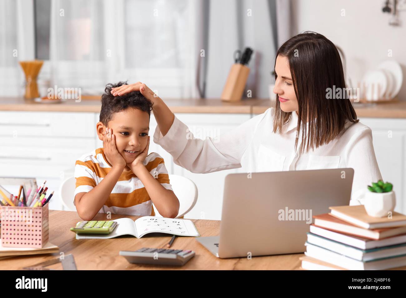 Little African-American boy studying with tutor at home Stock Photo - Alamy