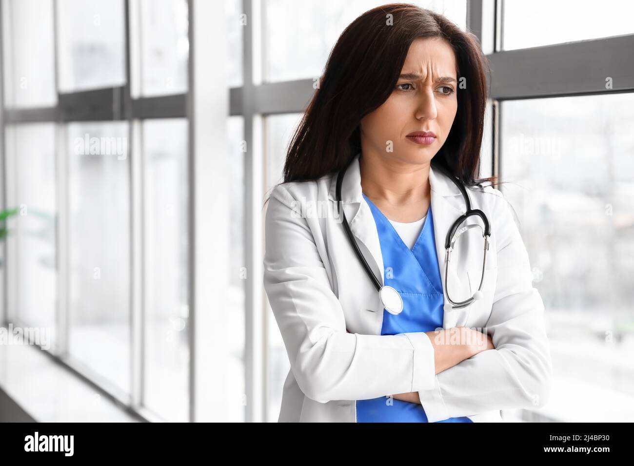 Worried female doctor in hall of clinic Stock Photo - Alamy