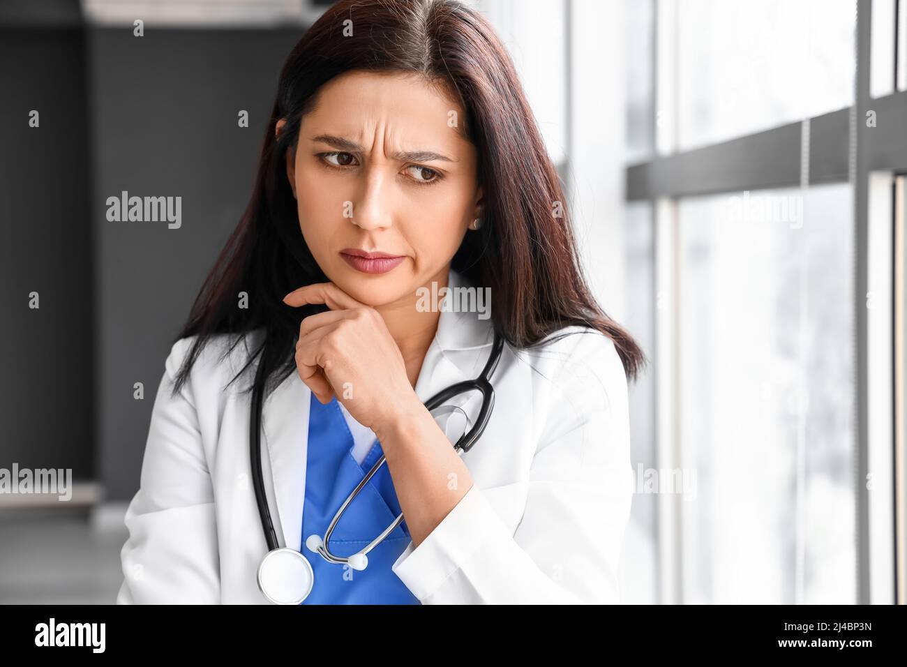 Worried female doctor in hall of clinic Stock Photo - Alamy