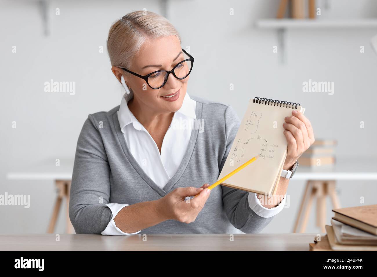 Female tutor giving lesson at home Stock Photo - Alamy