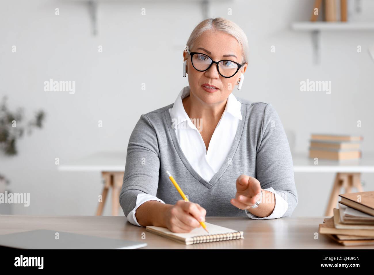 Female tutor giving lesson at home Stock Photo - Alamy
