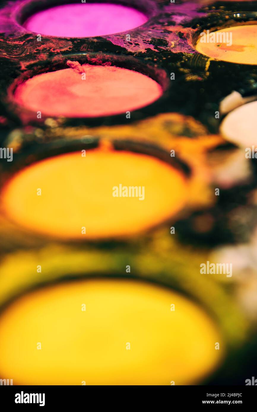 Vertical perspective view of paints palette with orange and pink colors ...