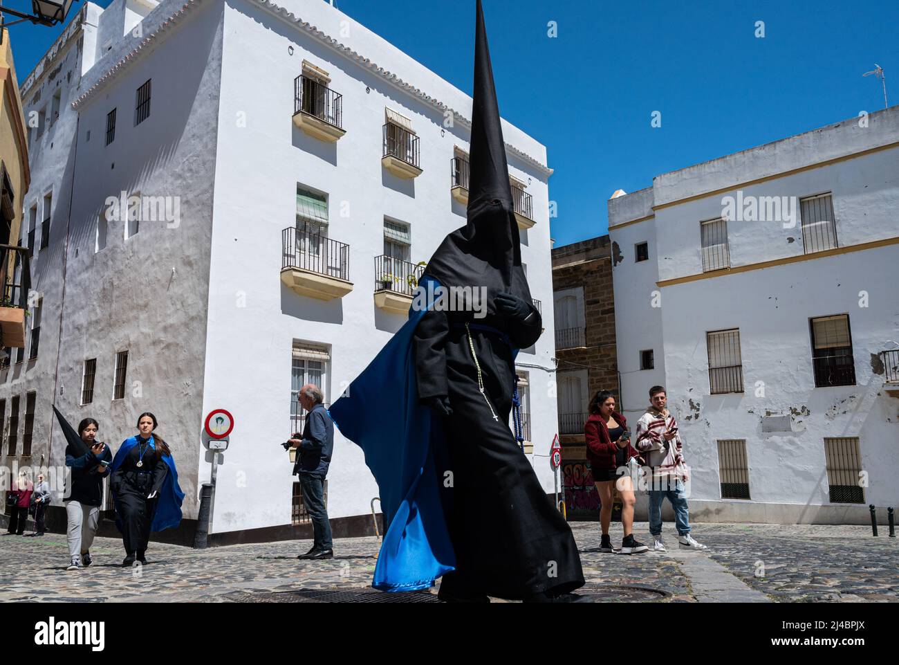 A penitent is seen on her way to a procession as worshippers celebrate ...