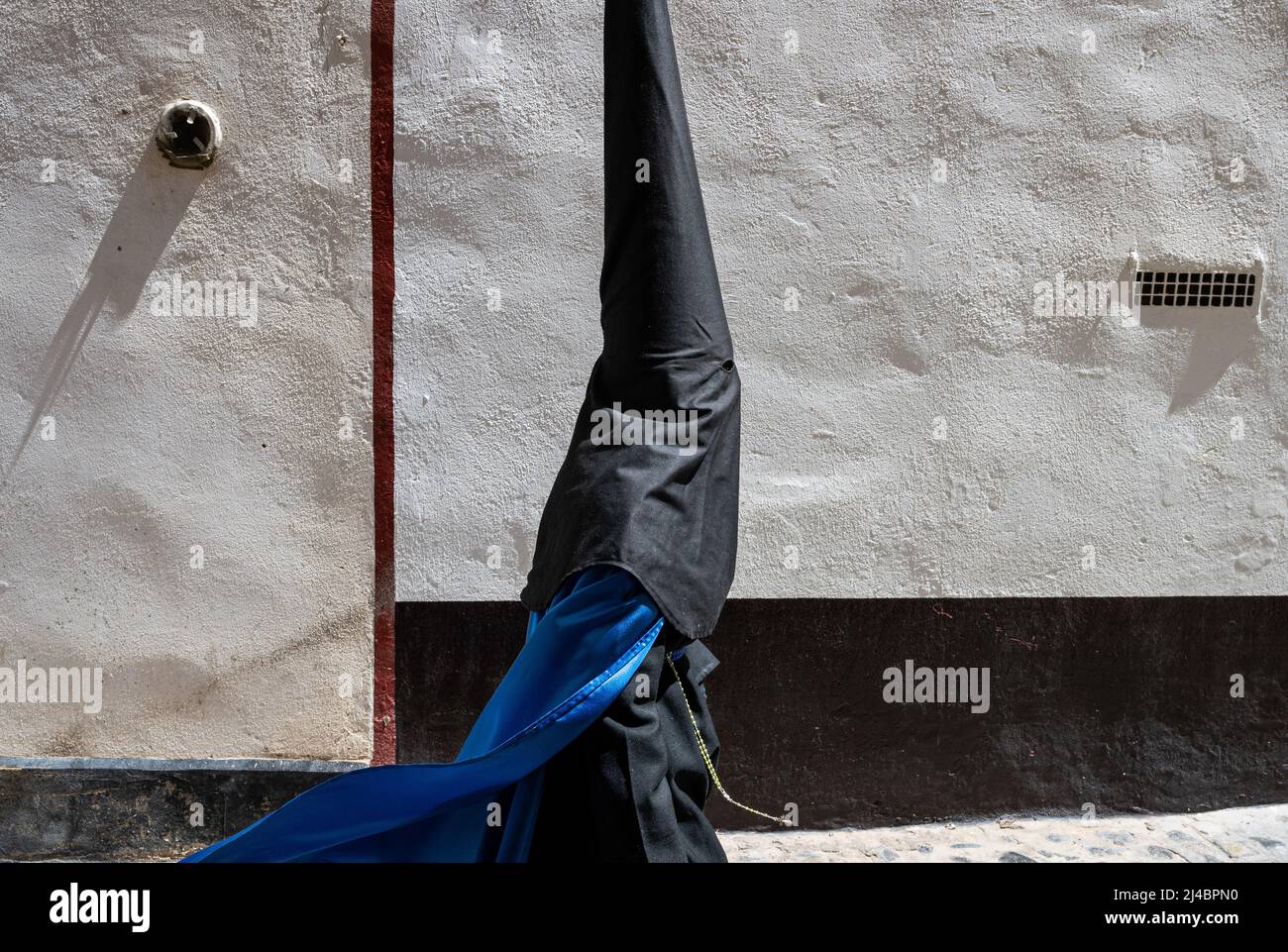 A penitent is seen on her way to a procession as worshippers celebrate ...