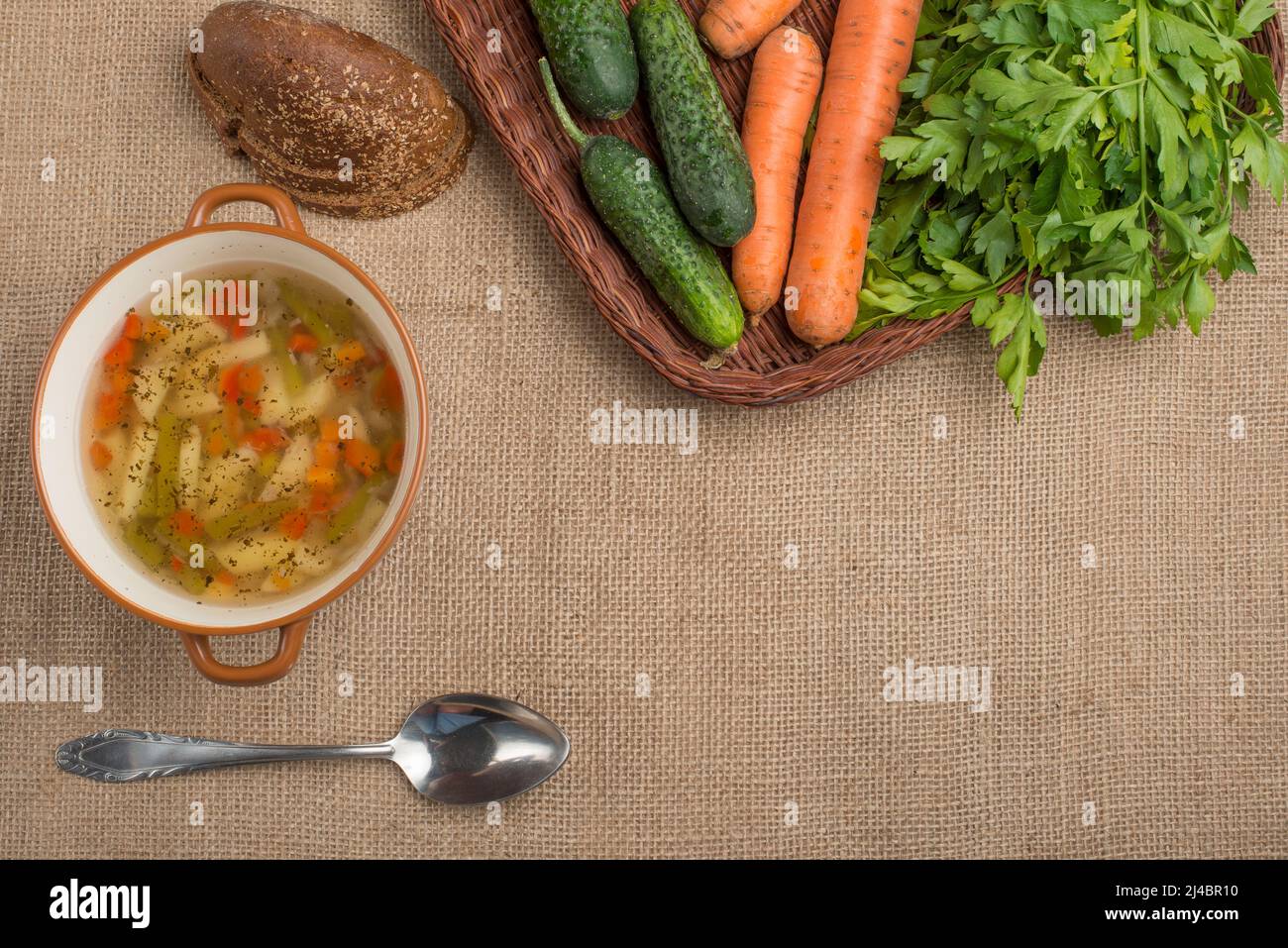 Vegetable soup, surrounded by fresh vegetables. With empty space for ...