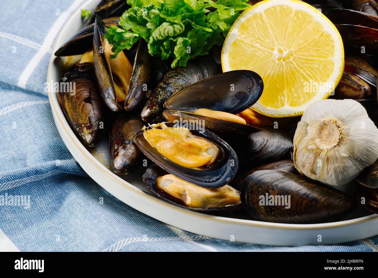 Shellfish dish. Seafood dishes. Mussels in sauce Stock Photo - Alamy