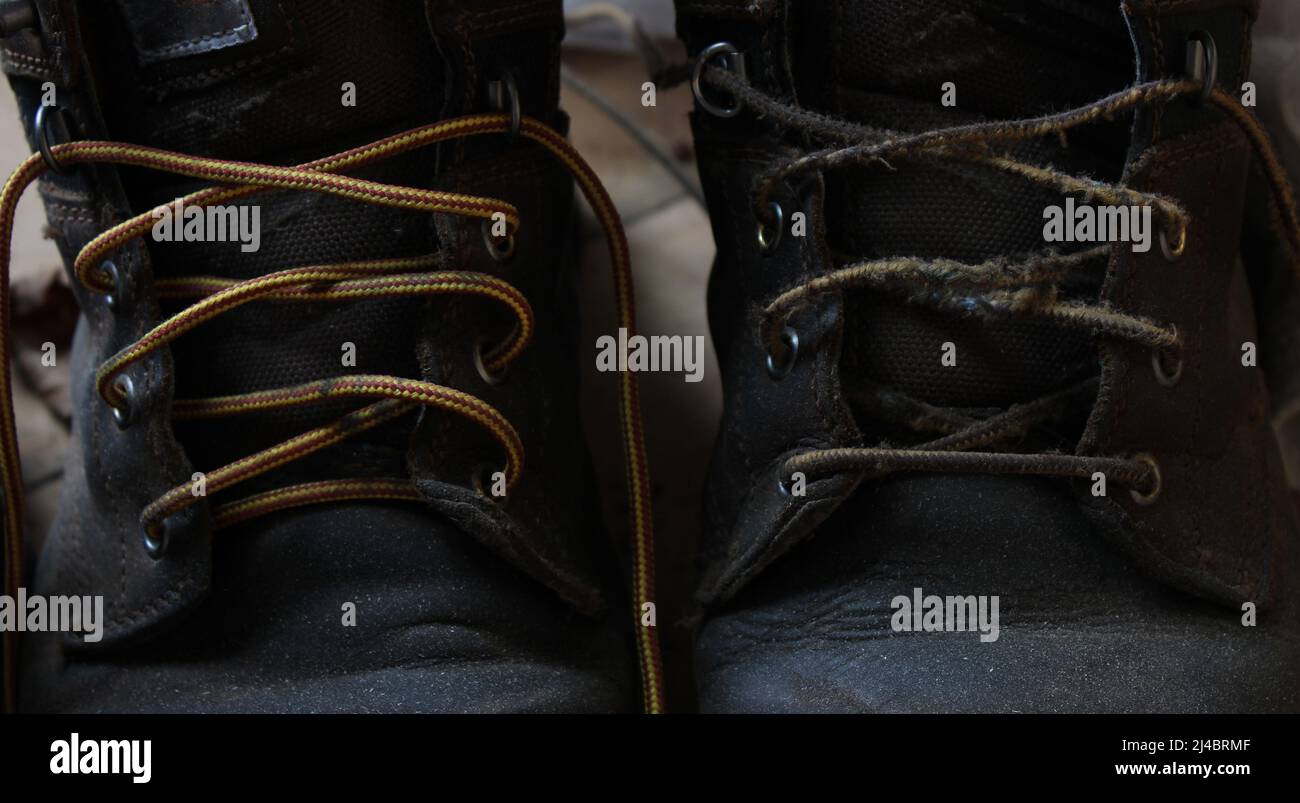 Mismatched Laces on a Pair of Old Work Boots Stock Photo - Alamy