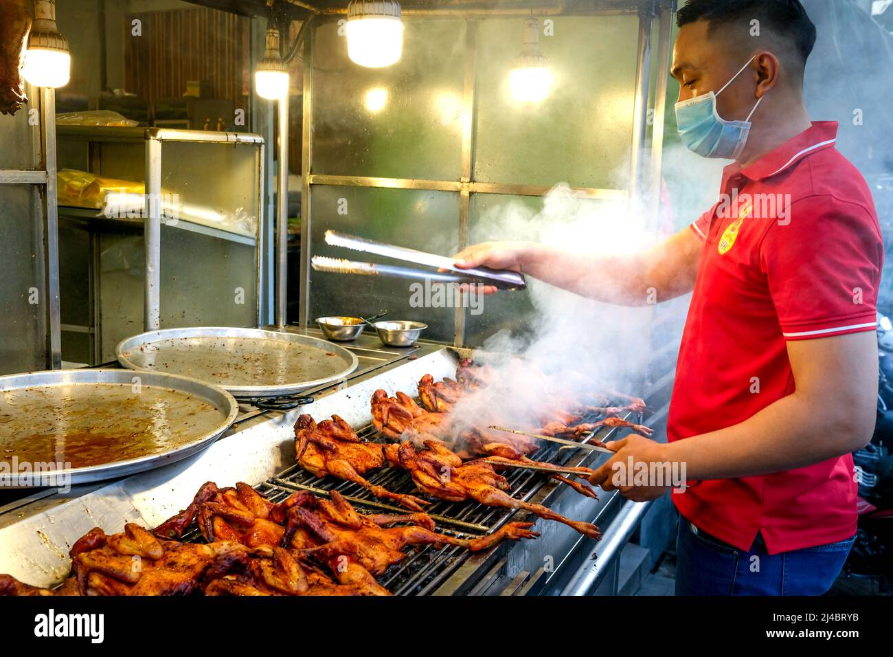 Ho Chi Minh City, Vietnam, April 13, 2022: Grilled chicken in a ceramic ...