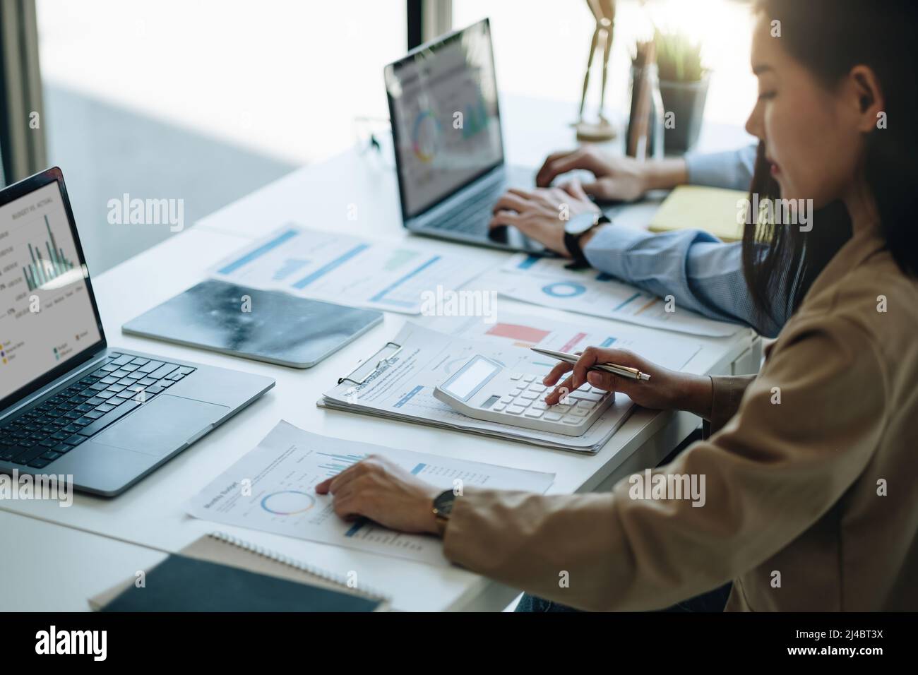 businesswoman accountant hand working on calculator to calculate ...