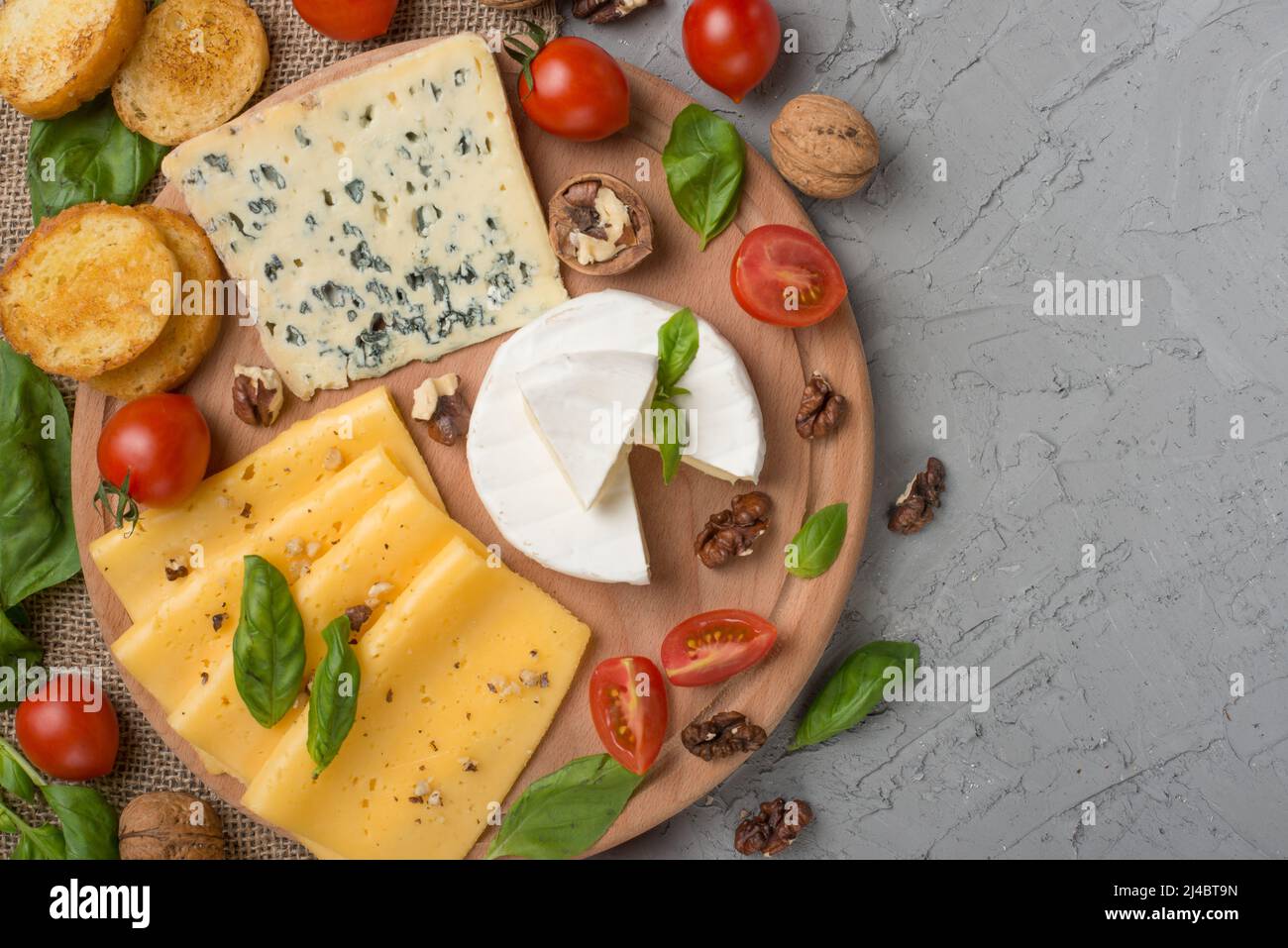 Different kinds of cheeses, with basil, cherry tomatoes, croutons from ...