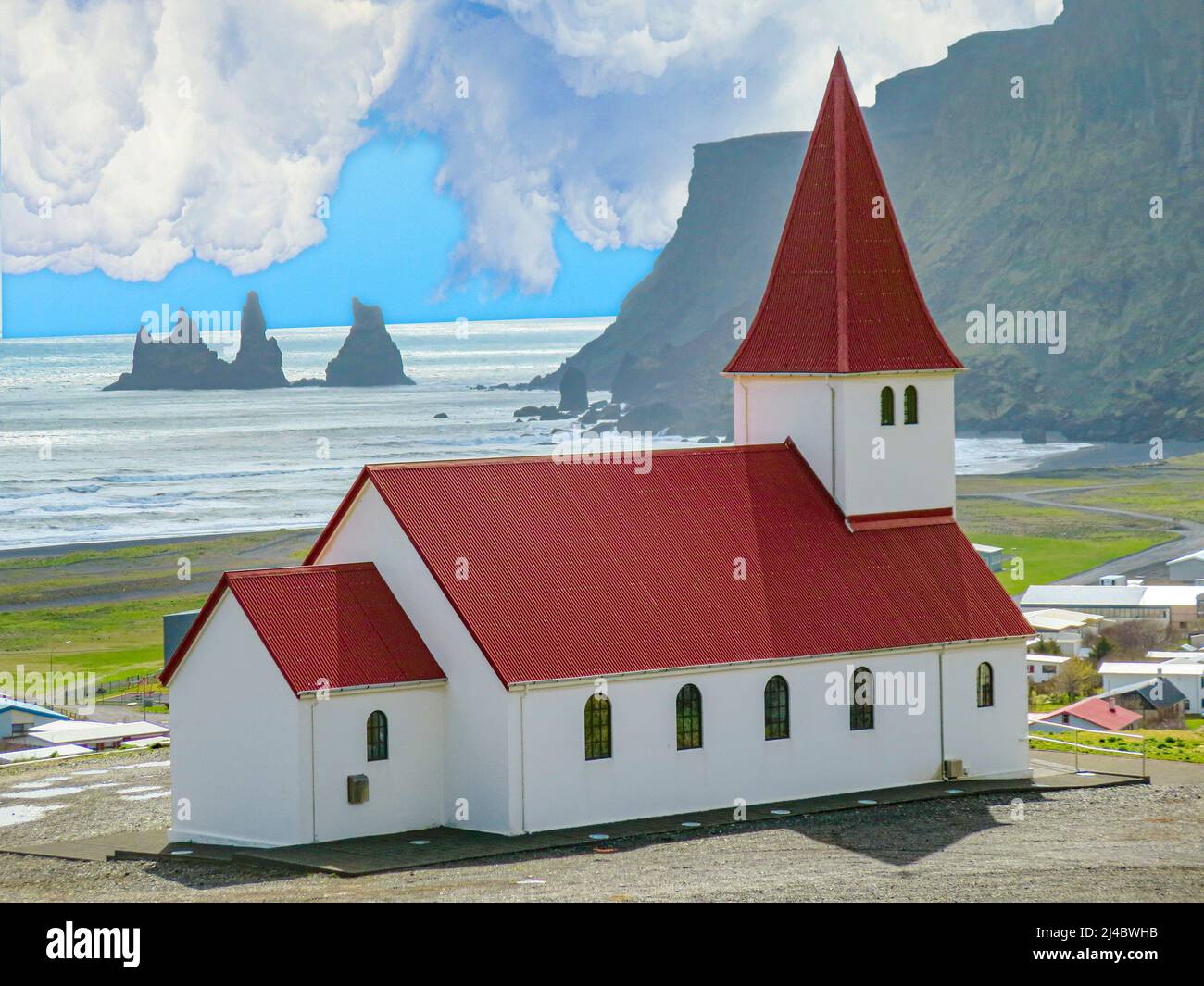 Typical red colored wooden church in Vik town, Iceland in winter ...
