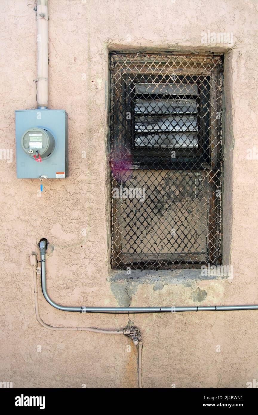 Electricity meter and barred window on wall Stock Photo - Alamy
