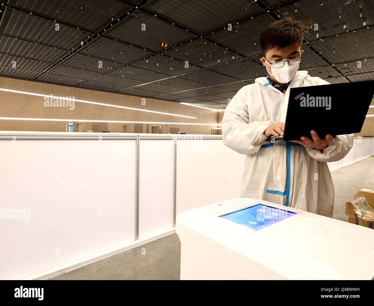 Shanghai. 13th Apr, 2022. An engineer works on a transportation robot ...