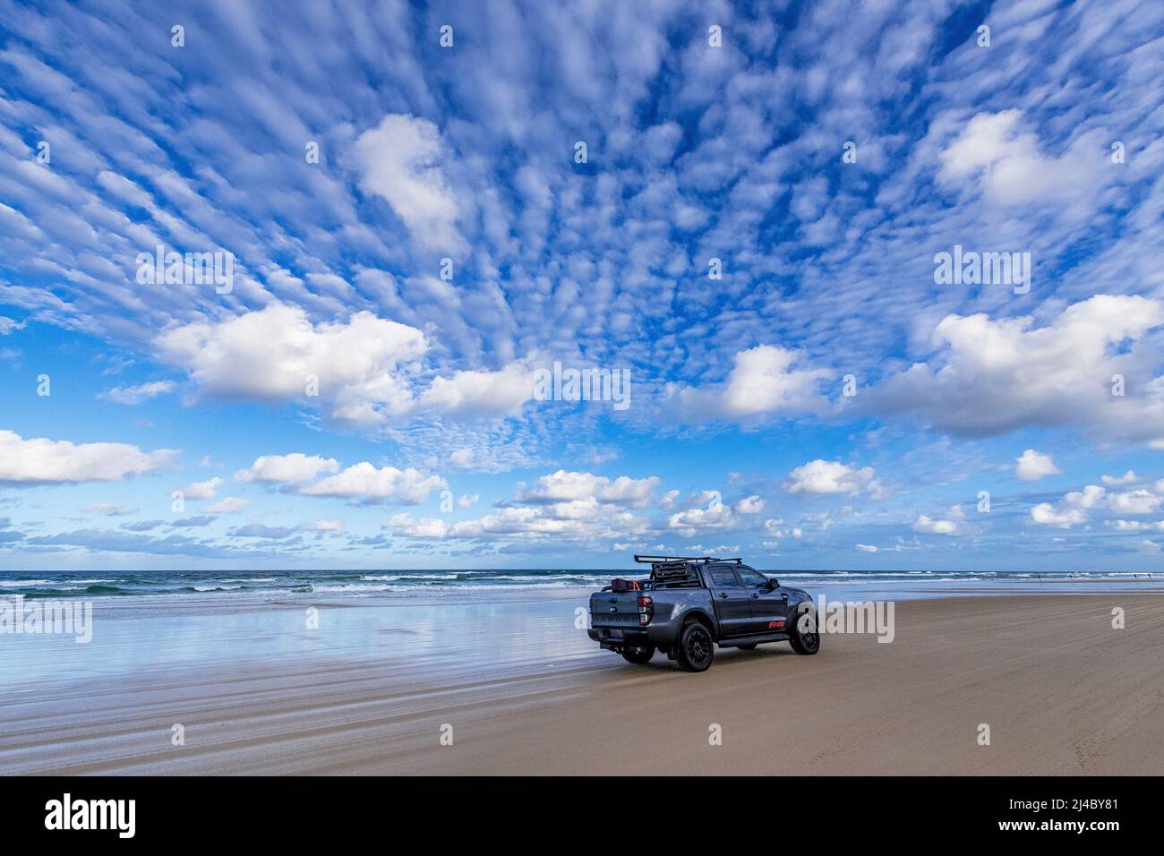 A 4wd dual cab ute driving along 75 mile beach on Fraser Island ...