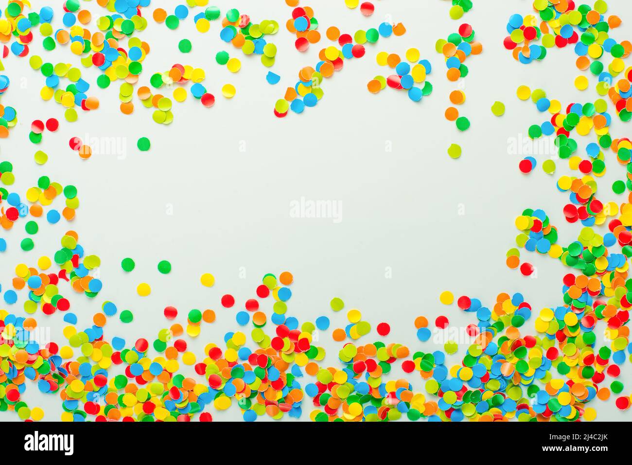 Confetti scattered in different colors on a white background. Festive ...