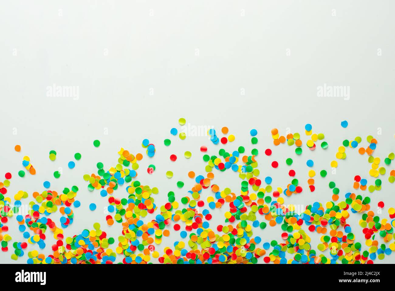 Confetti scattered in different colors on a white background. Festive ...