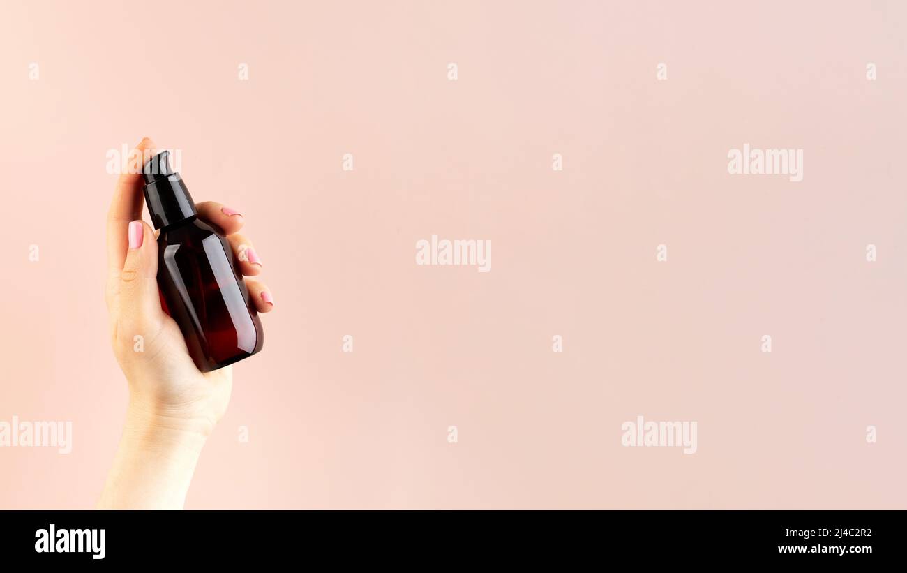 A mock-up of a brown dispenser with a natural cosmetic product in a ...