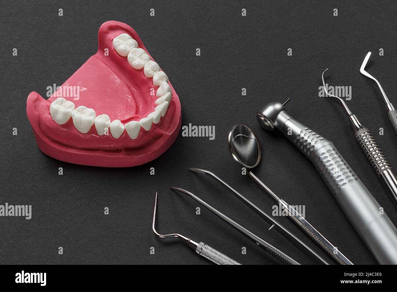 Layout of the human jaw. Plugger, tweezers, a mouth mirror, a dental ...