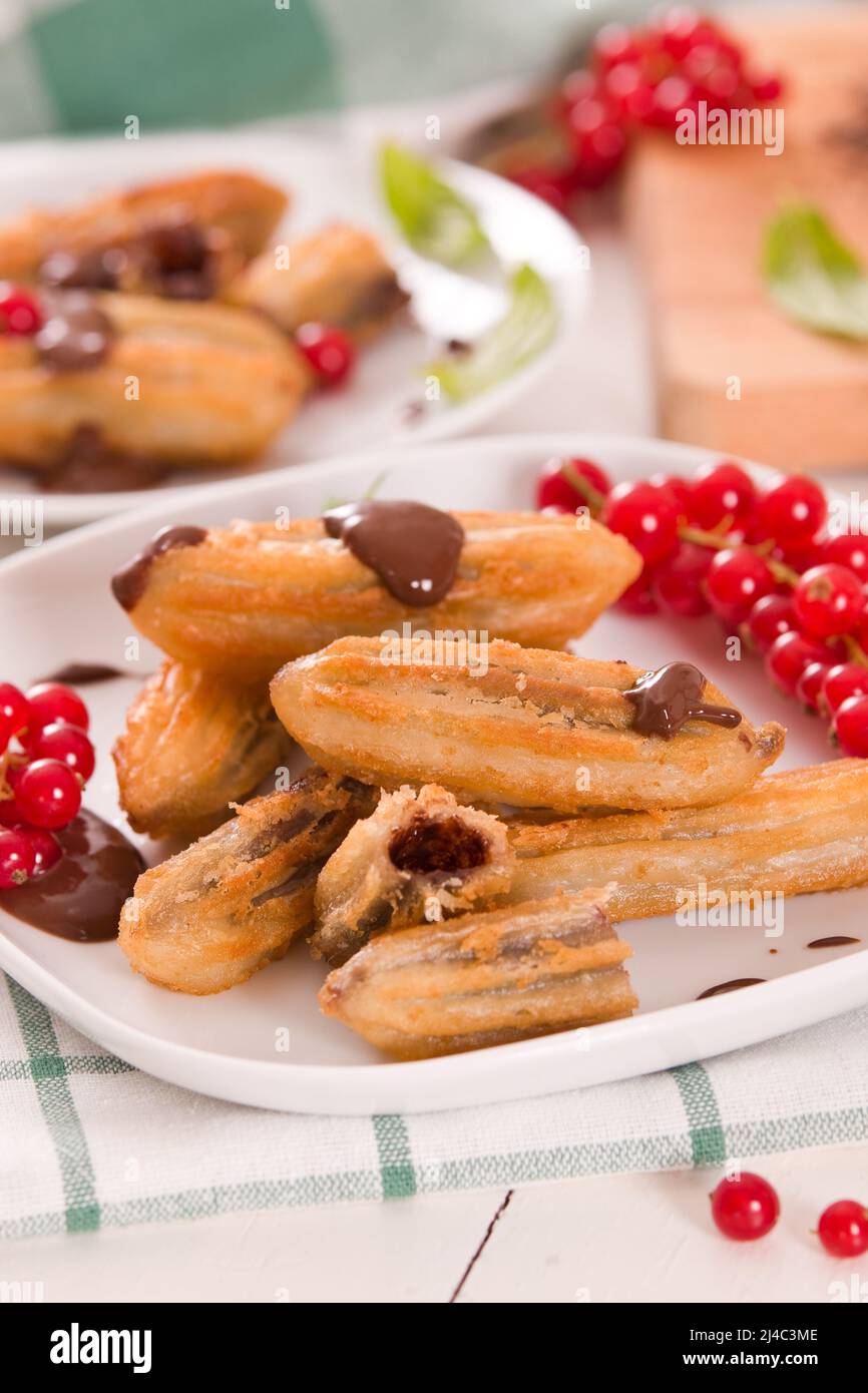 Mini churros with chocolate dipping sauce Stock Photo - Alamy