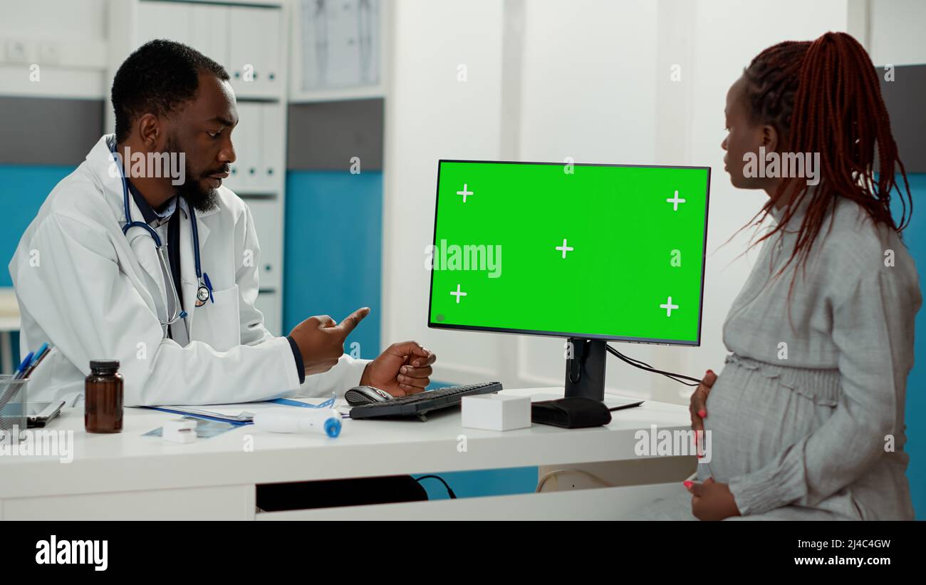 African american people looking at greenscreen on computer in cabinet ...