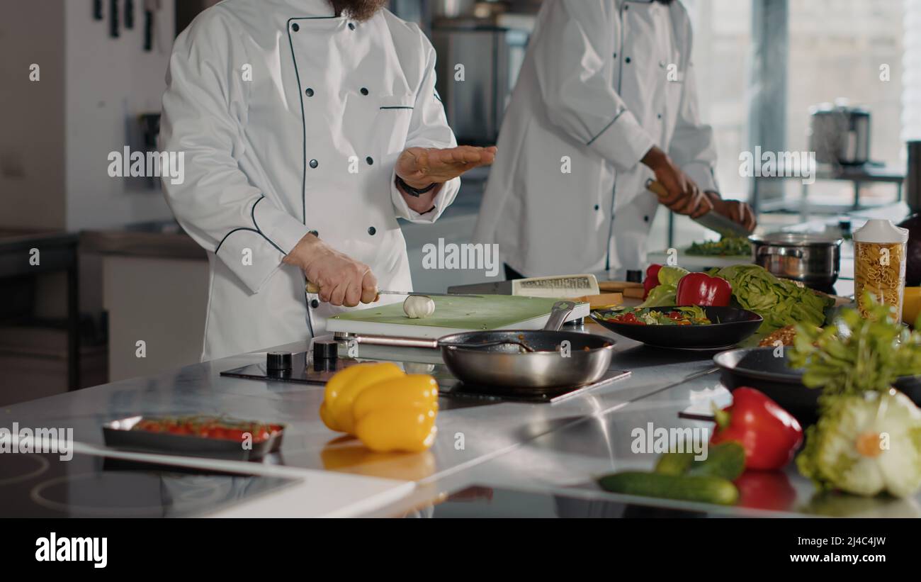 Authentic chef cooking vegetarian meal with garlic clove in ...