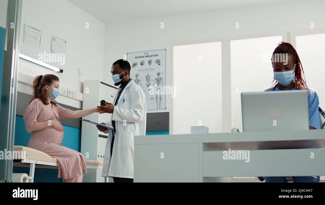 Doctor giving patient documents hi-res stock photography and images - Alamy