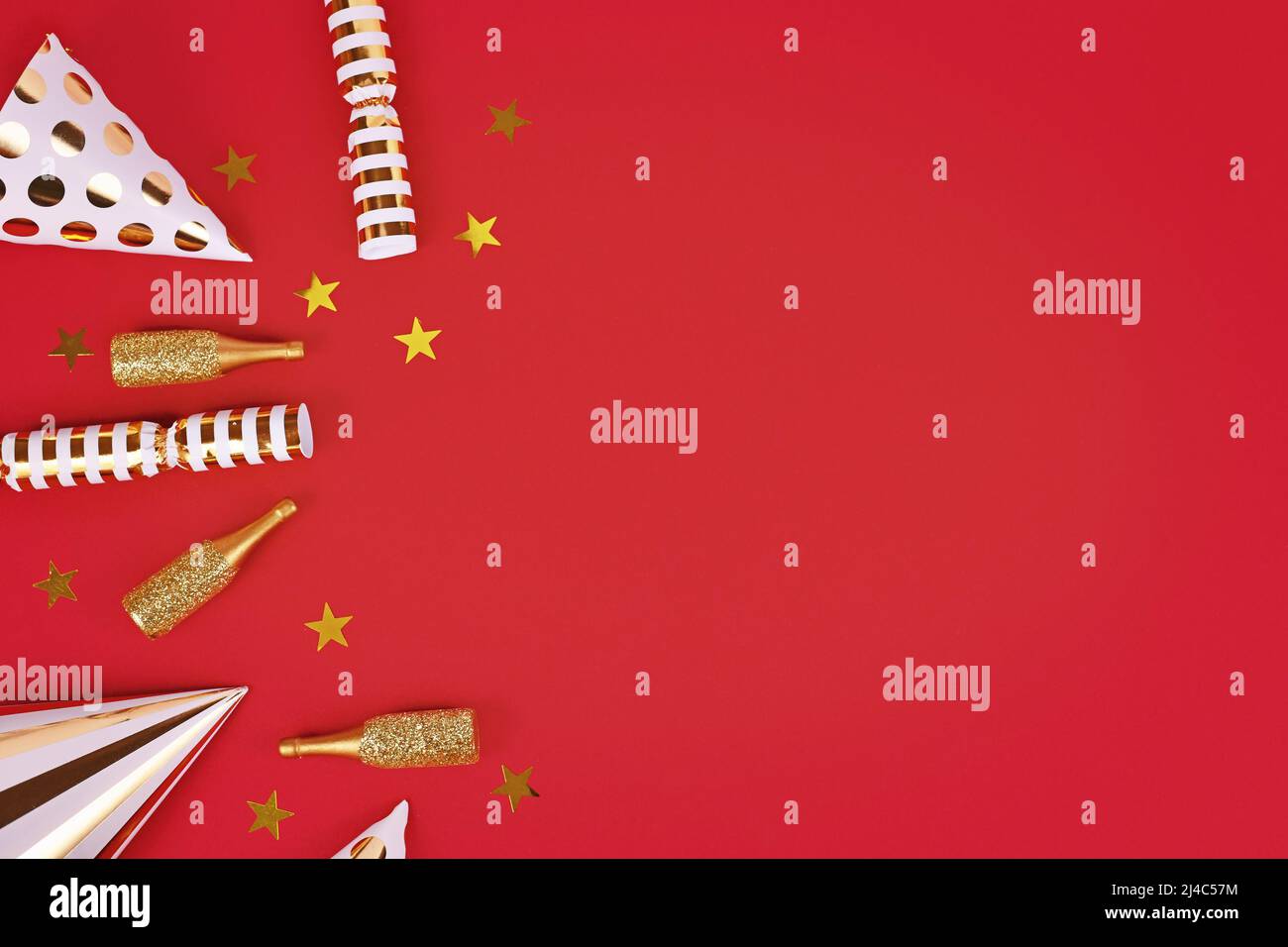 Golden party objects like hats, confetti and gifts on red background ...