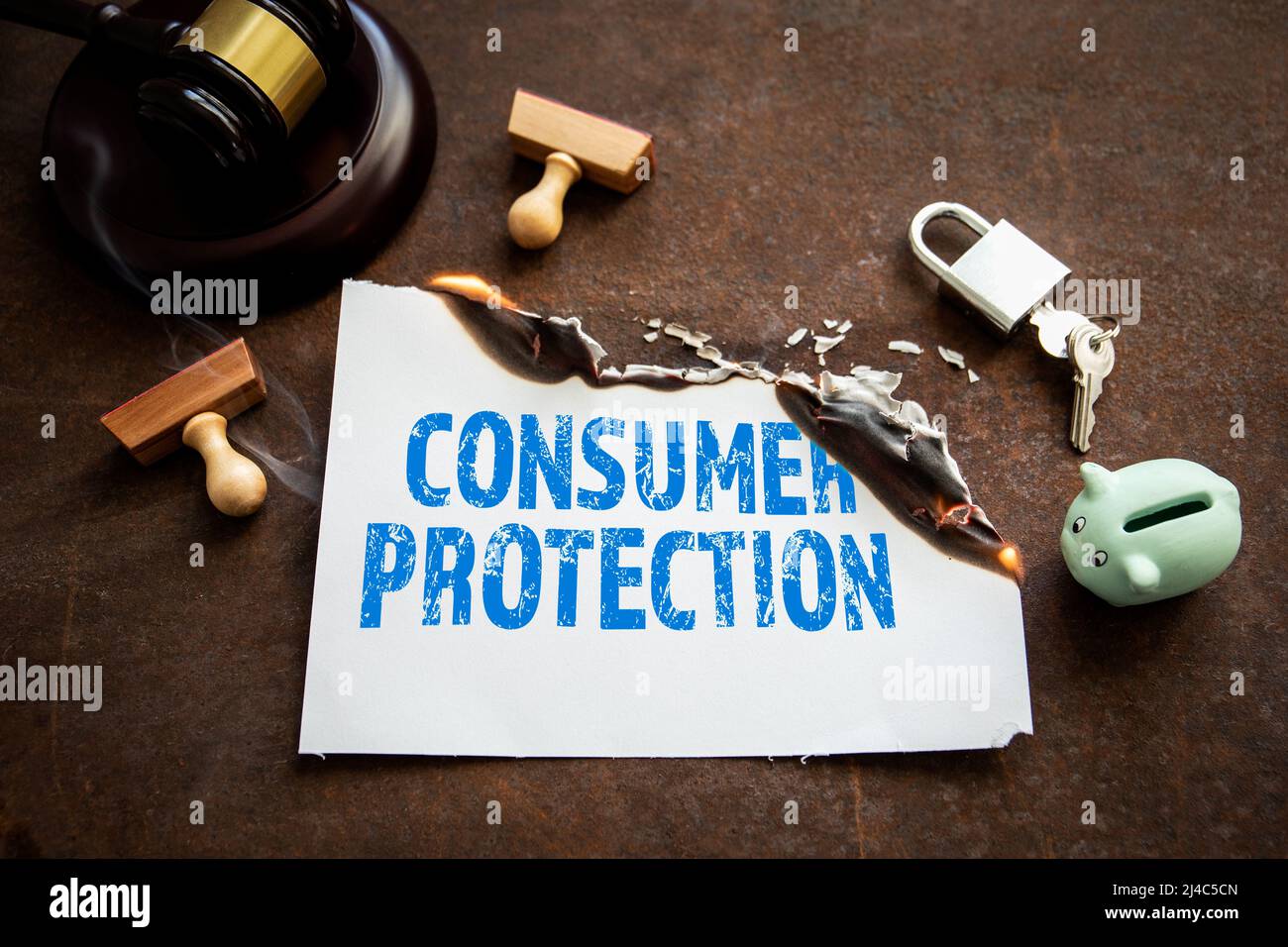 Consumer protection concept. Burning sheet of paper with text. Rusty ...