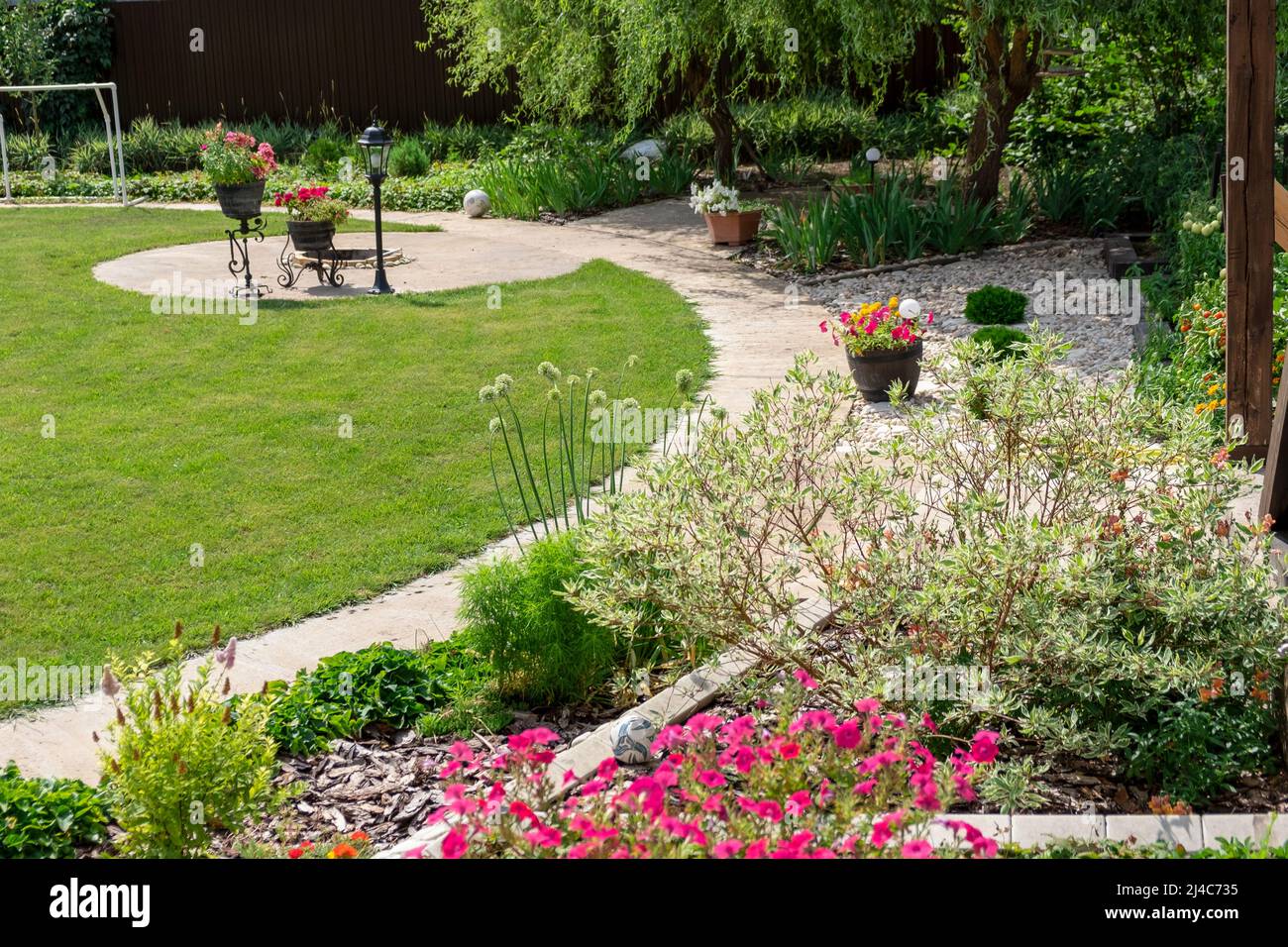 Beautiful backyard landscape design. View of colorful trees and ...