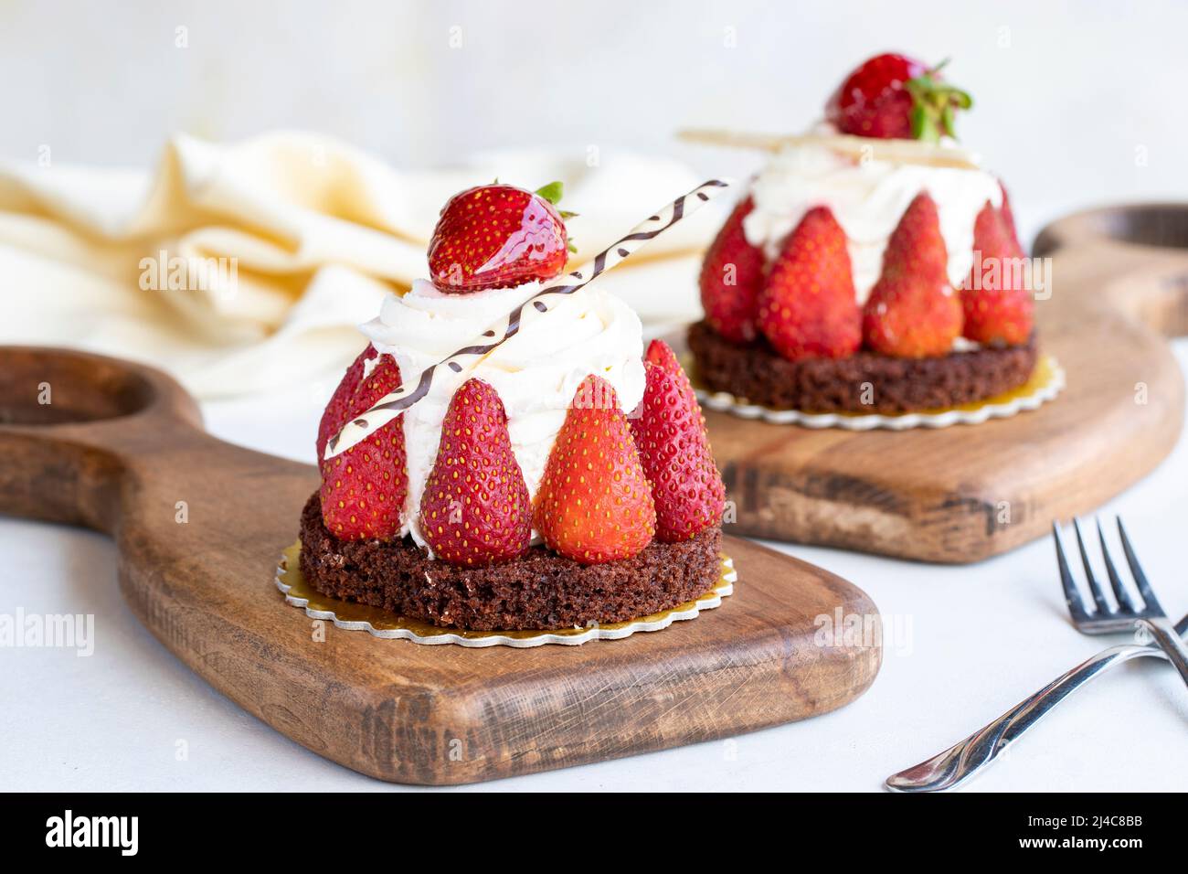 Strawberry cake. Cake filled with cream in the middle, surrounded by ...
