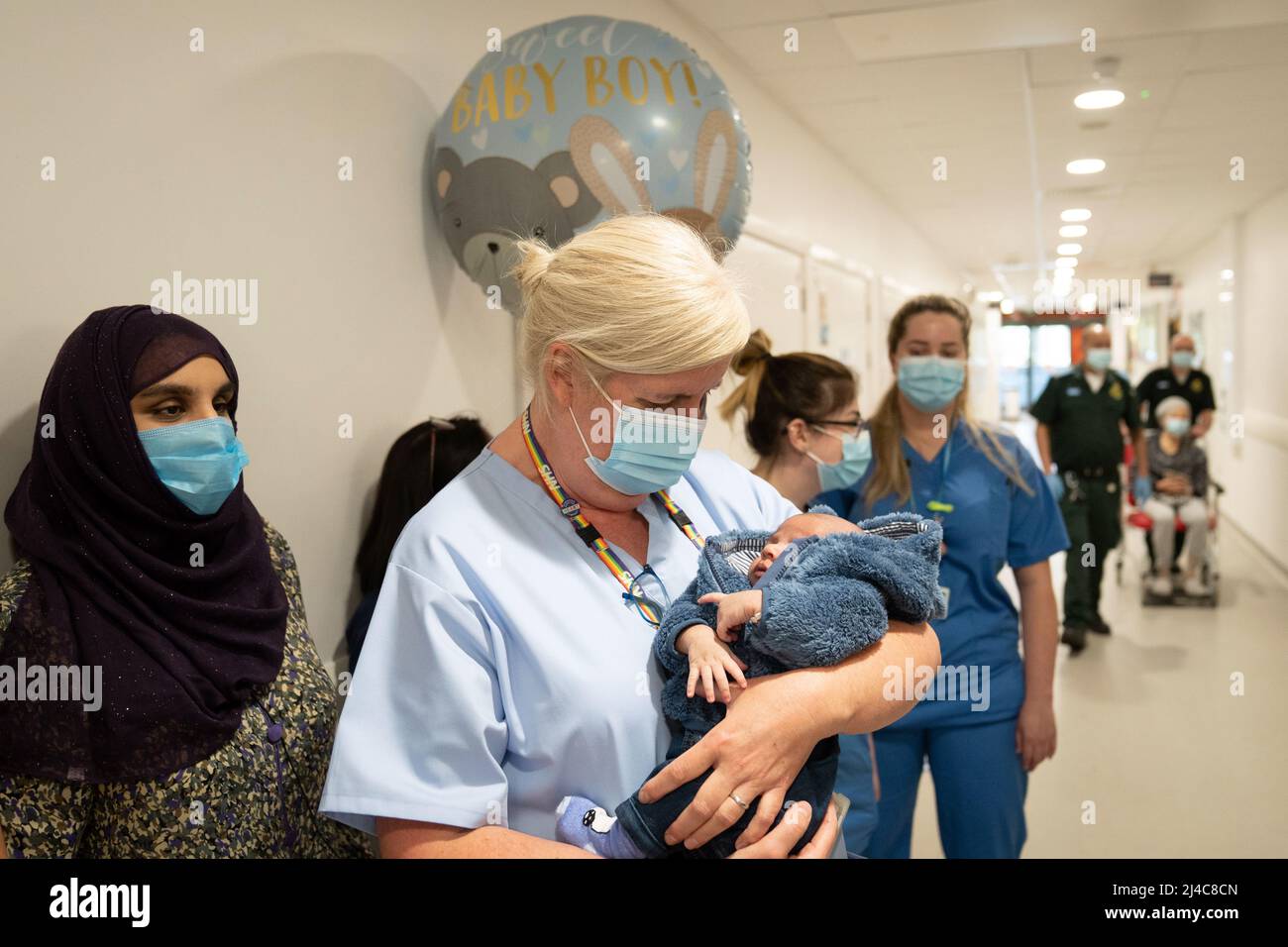 A&E nurse Helen Flanagan holds two-week-old baby Mohammed Ibrahim at ...