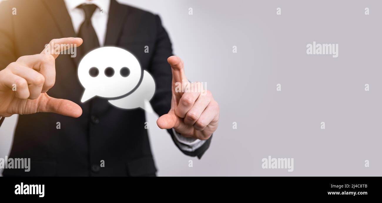 Businessman holding a message icon, bubble talk notification sign in ...