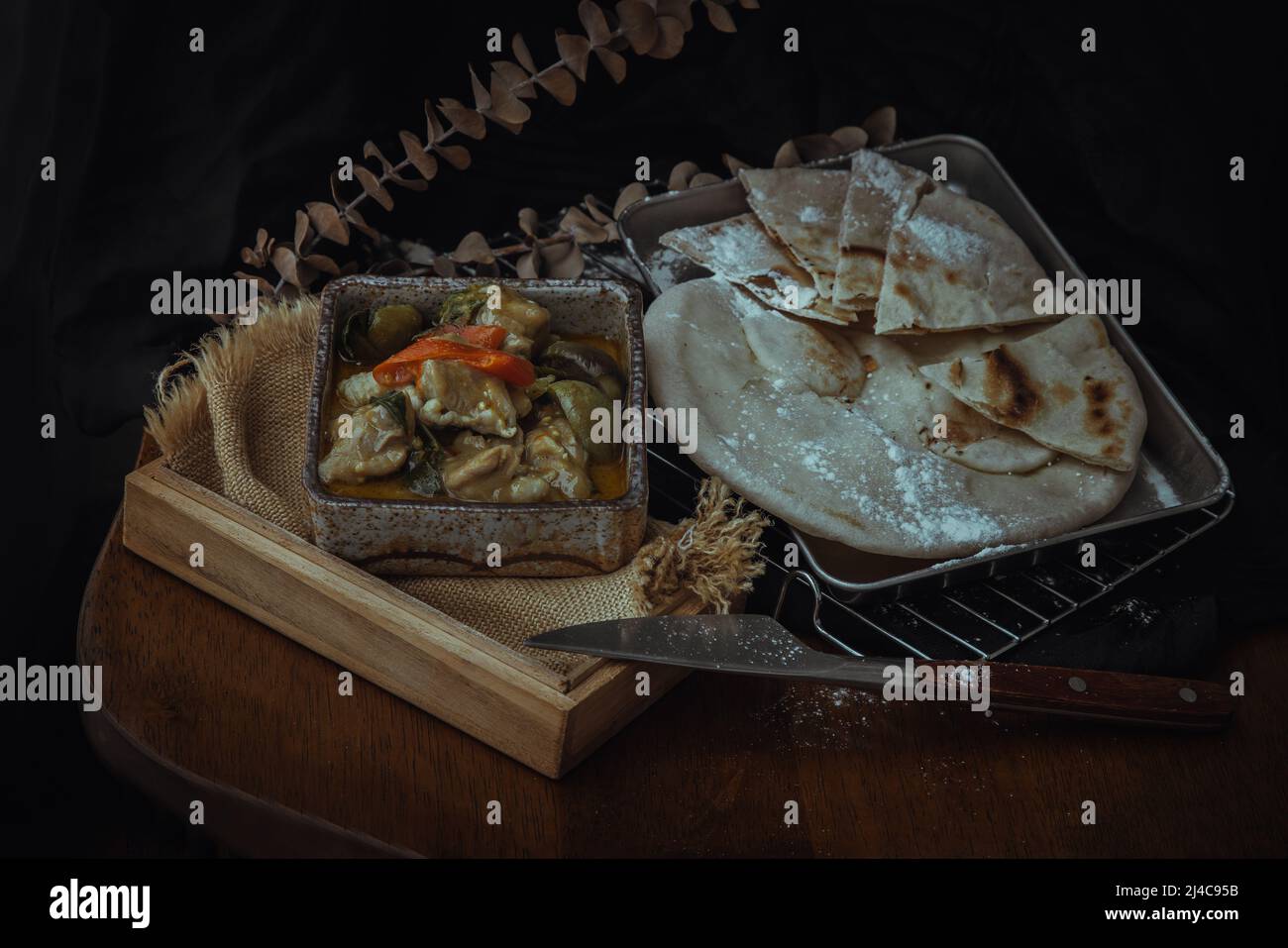 Homemade pita bread served with Green curry chicken (Kaeng khiao wan ...