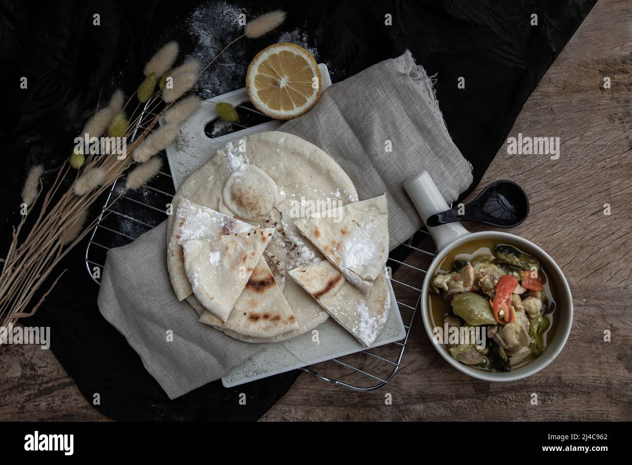 Homemade pita bread served with Green curry chicken (Kaeng khiao wan ...