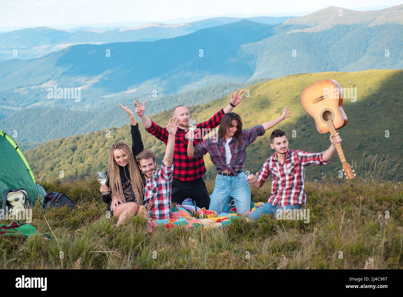Group of happy excited friends on country walk. Young people rest in ...