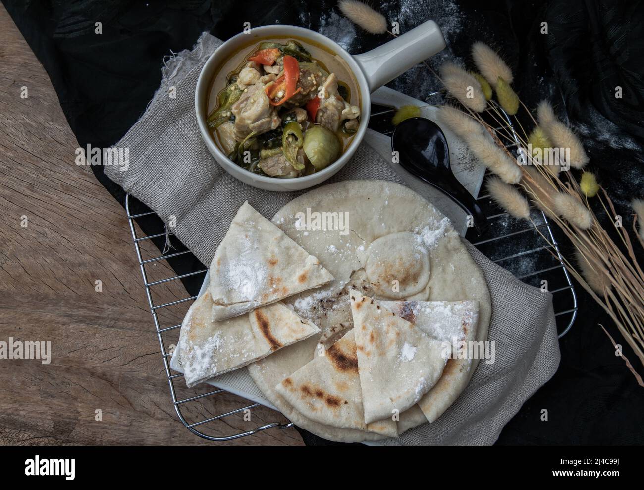 Homemade pita bread served with Green curry chicken (Kaeng khiao wan ...