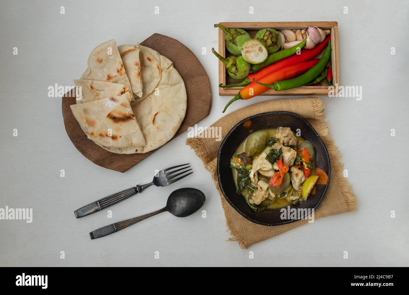 Homemade pita bread served with Green curry chicken (Kaeng khiao wan ...