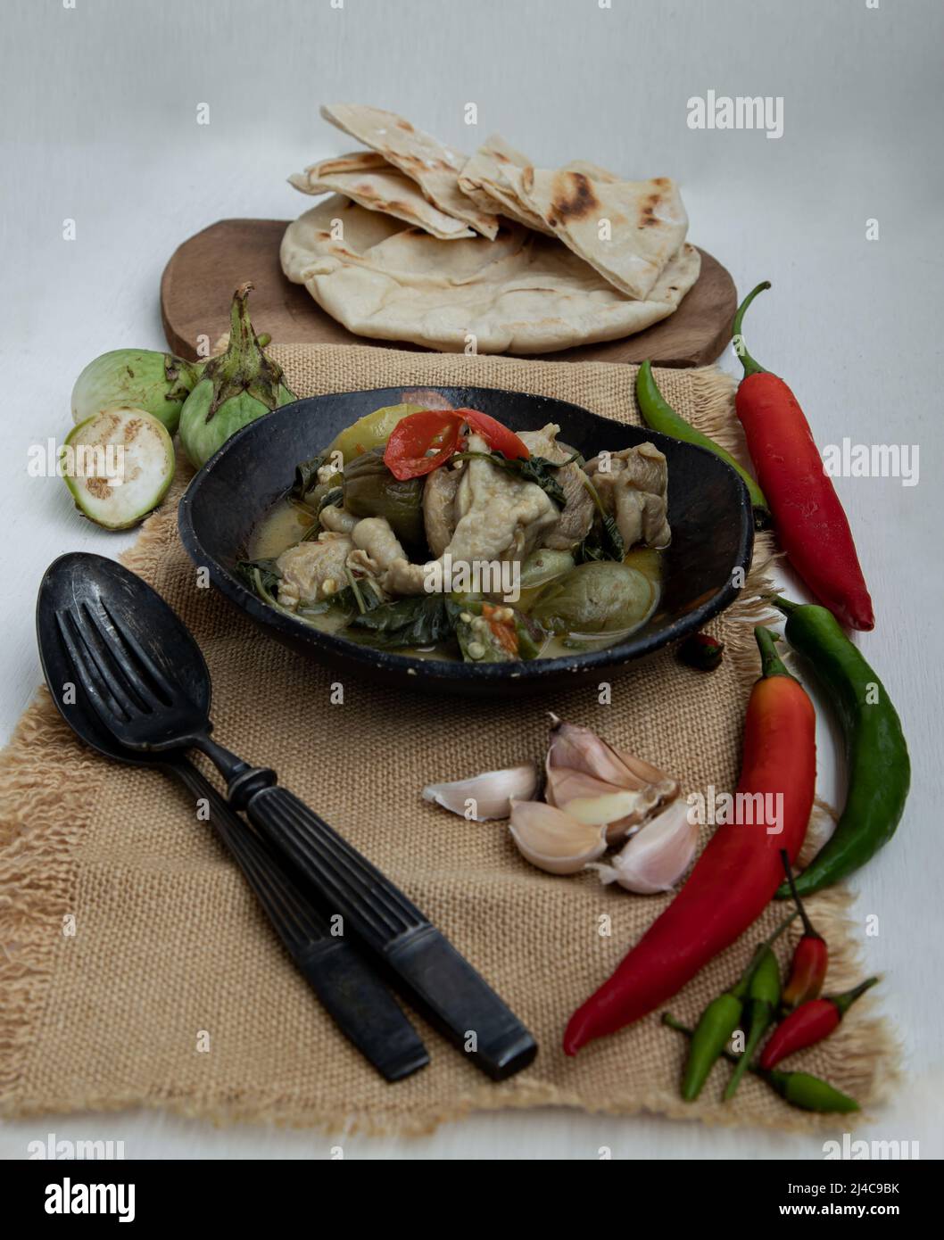 Homemade pita bread served with Green curry chicken (Kaeng khiao wan ...