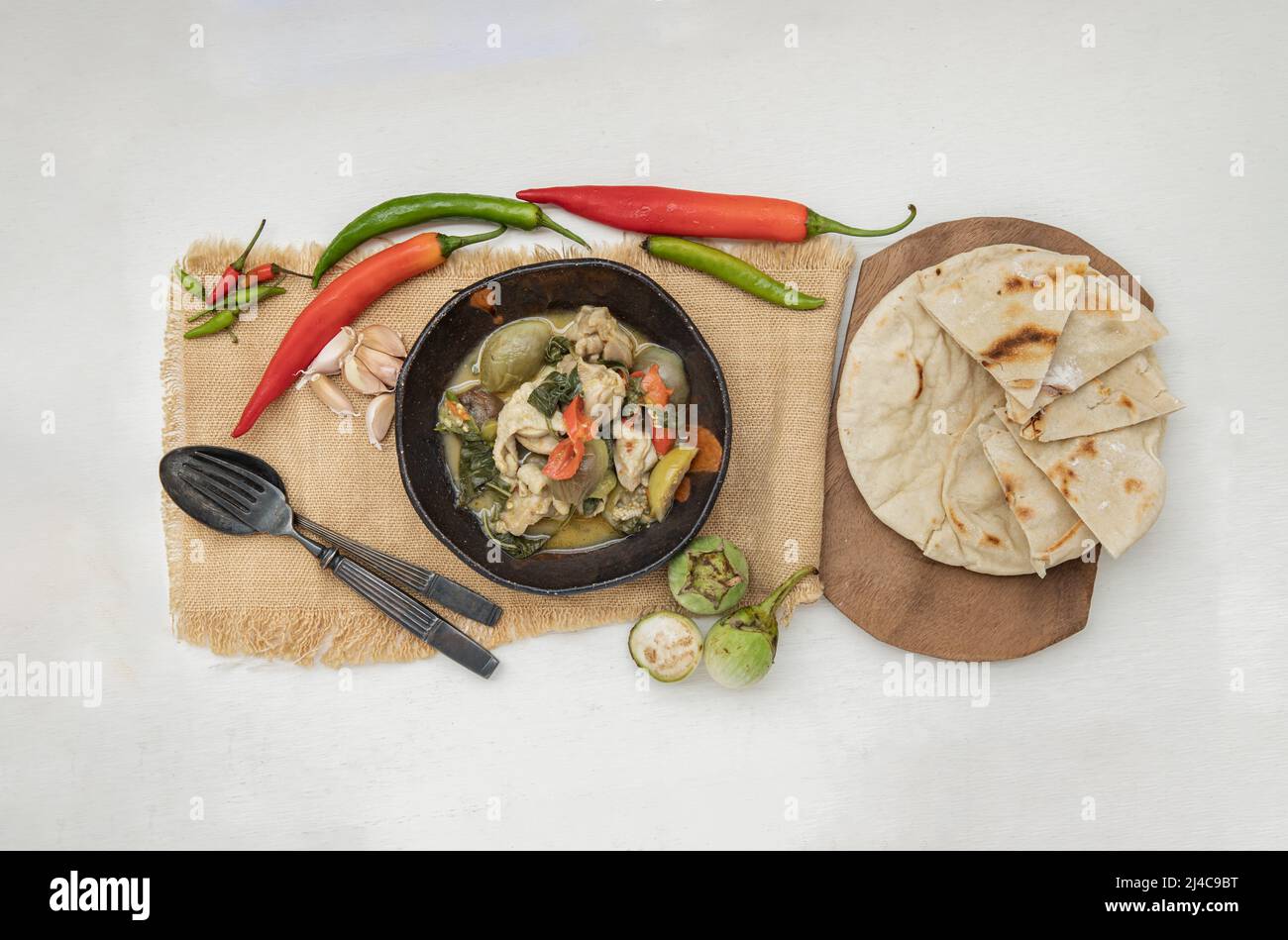 Homemade pita bread served with Green curry chicken (Kaeng khiao wan ...