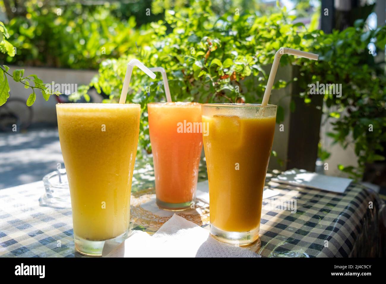 organic juices on small table with tropical view Stock Photo - Alamy