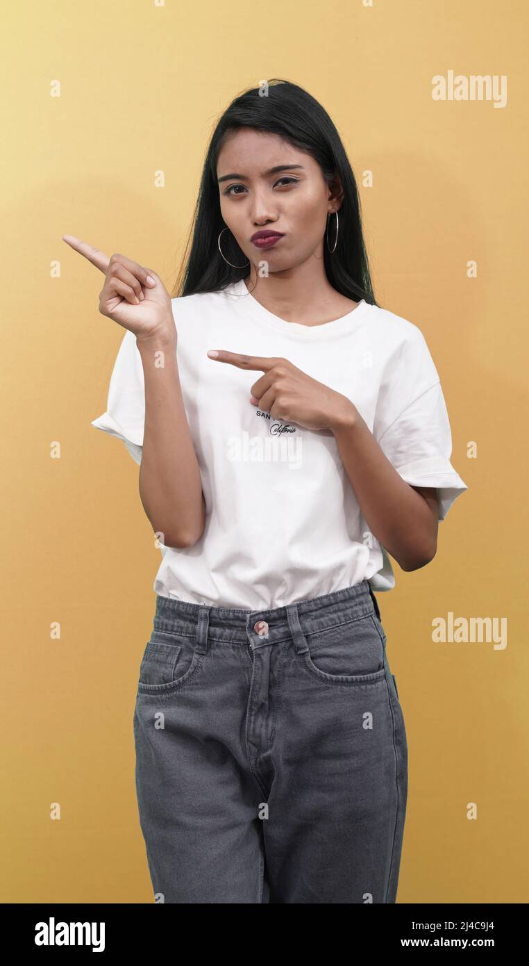 Confused young woman frowning, judging, smirk and look upset and ...