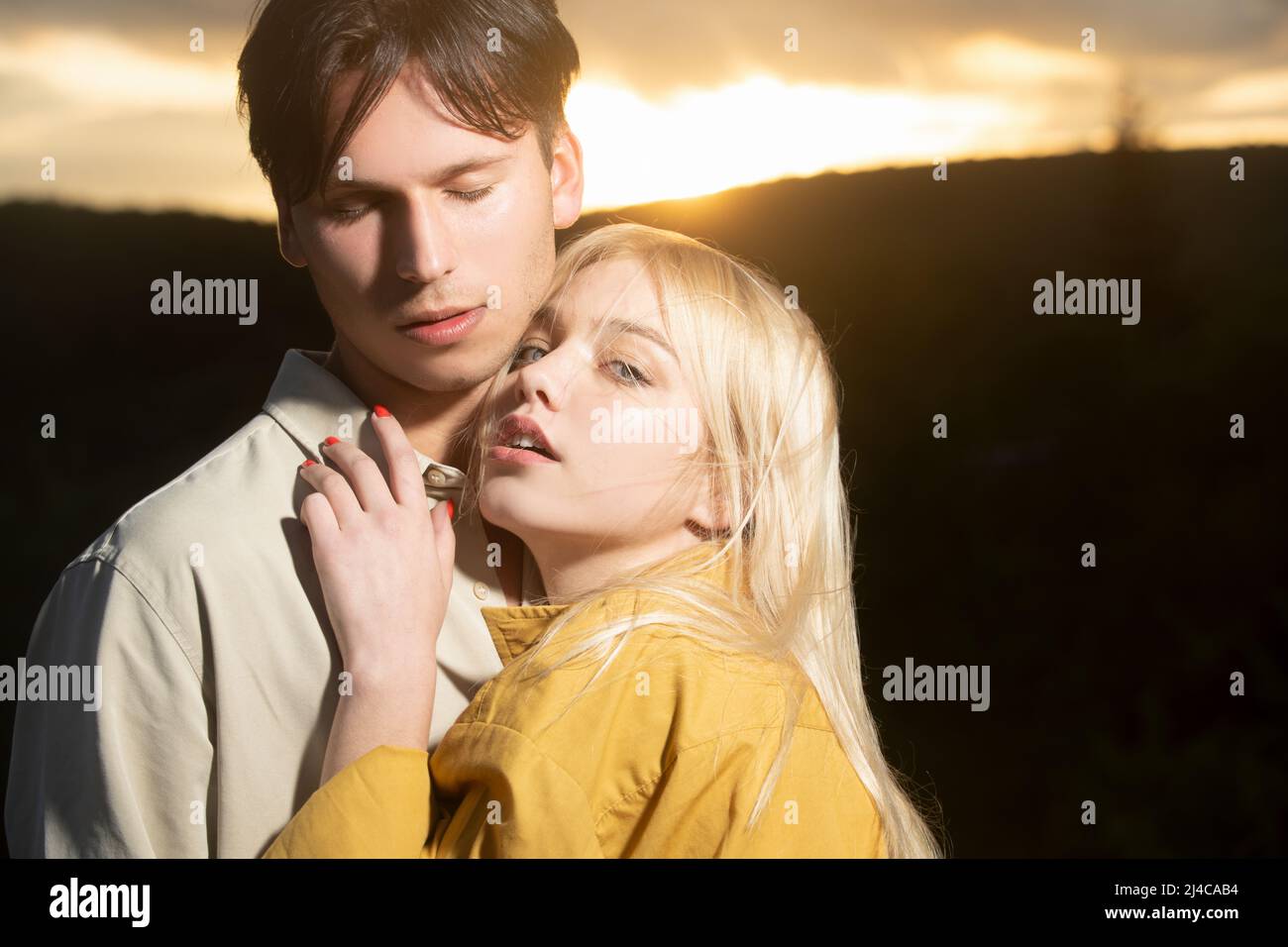 Young lovers hugging and embracing. Tenderness couple touch. Couple in ...