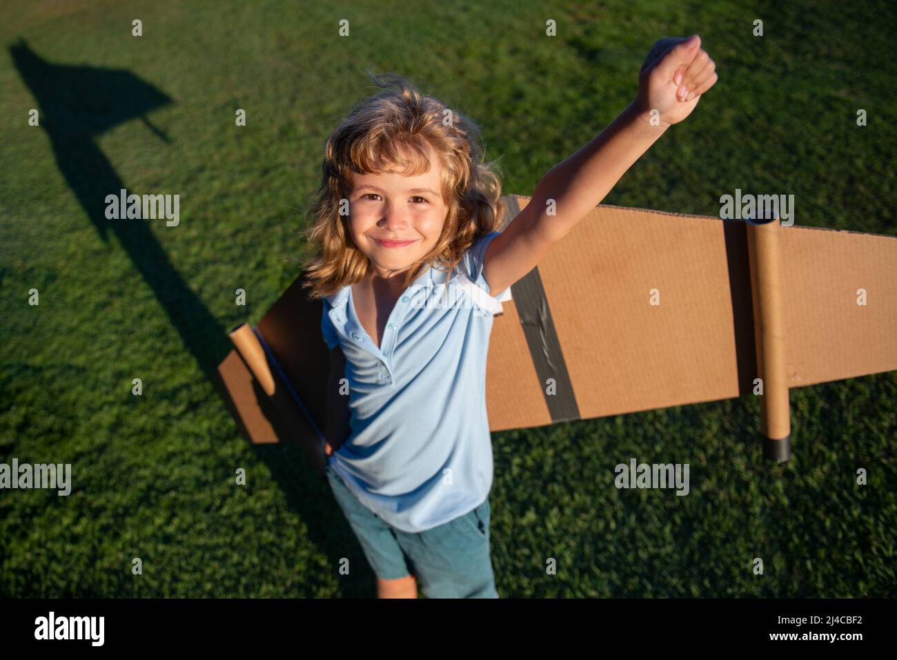 Excited kid superhero with jetpack. Child pilot play on summer day ...