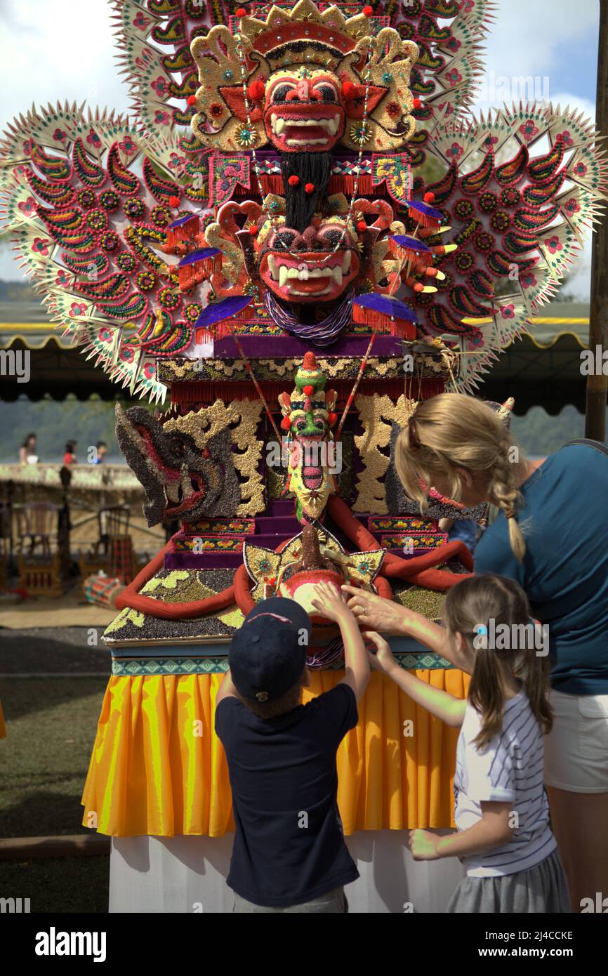 Woman and children tourists paying attention to a traditional ...