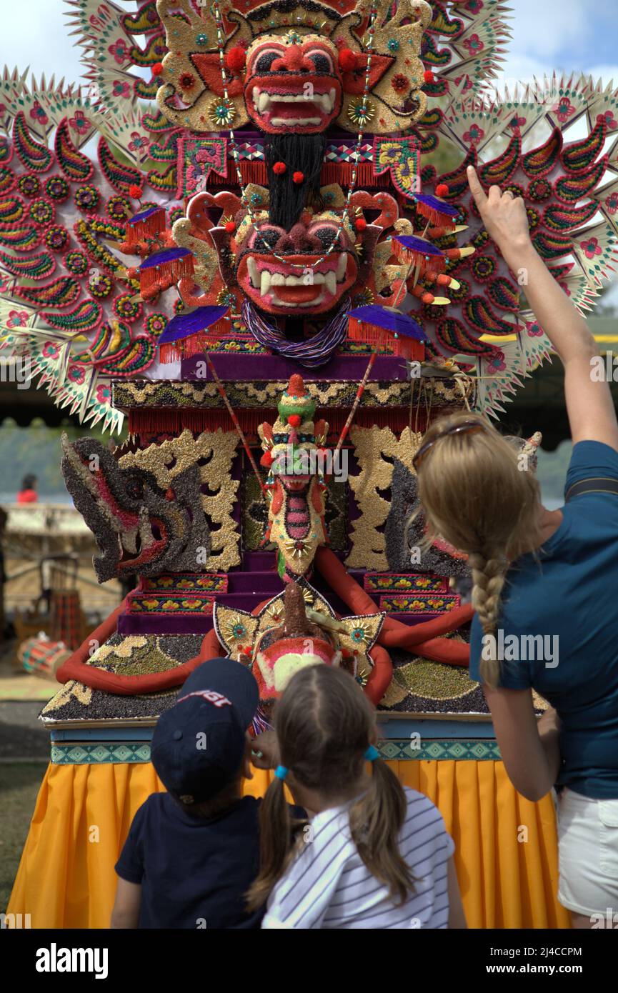 Woman and children tourists paying attention to a traditional ...