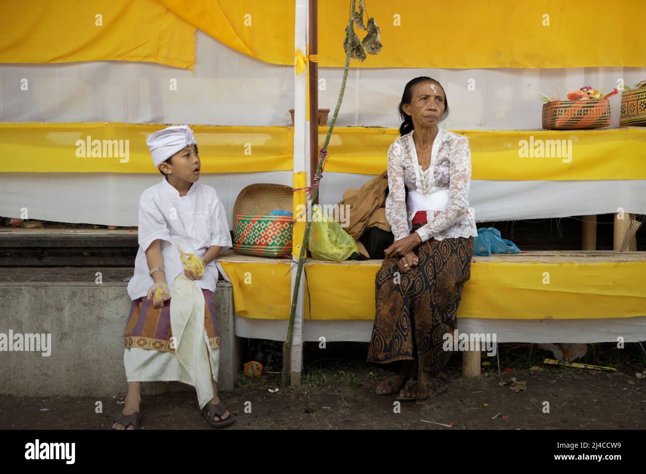 A woman and a child having a rest after traditional ceremony near Ulun ...