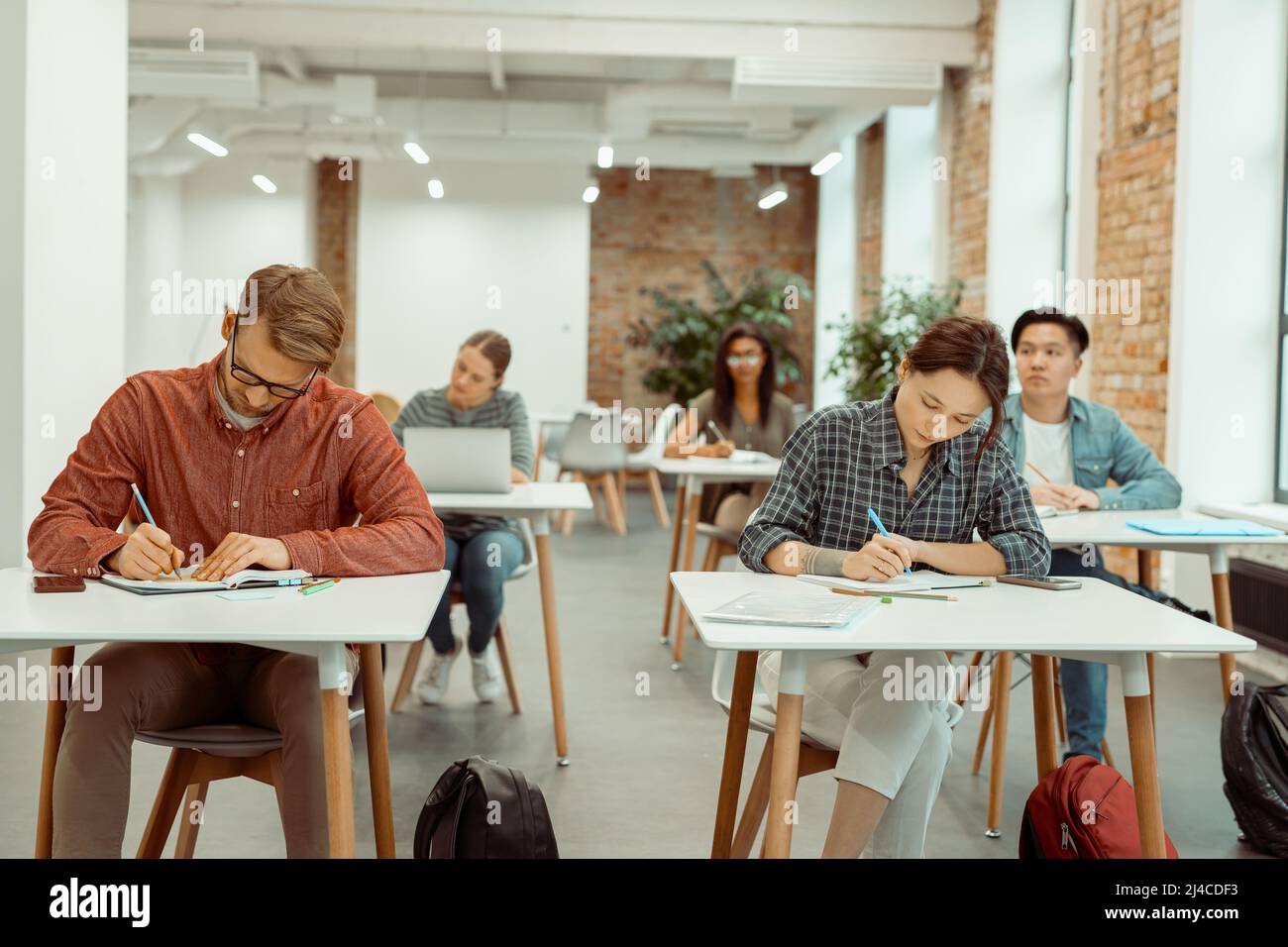Group of university students taking a test Stock Photo - Alamy