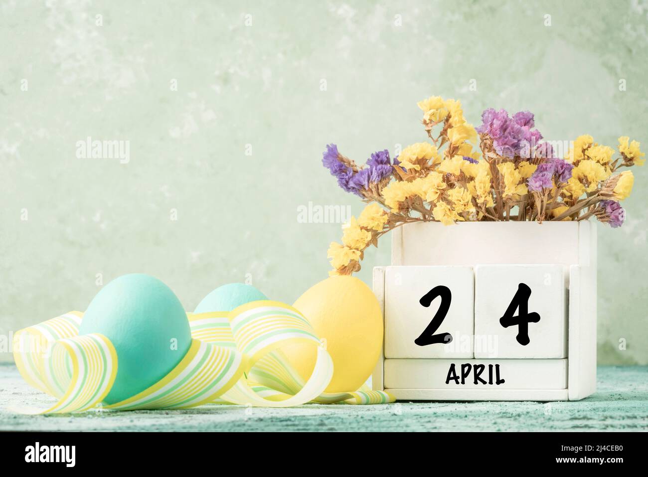 Easter, white cube calendar for Easter in April on table decorated with ...