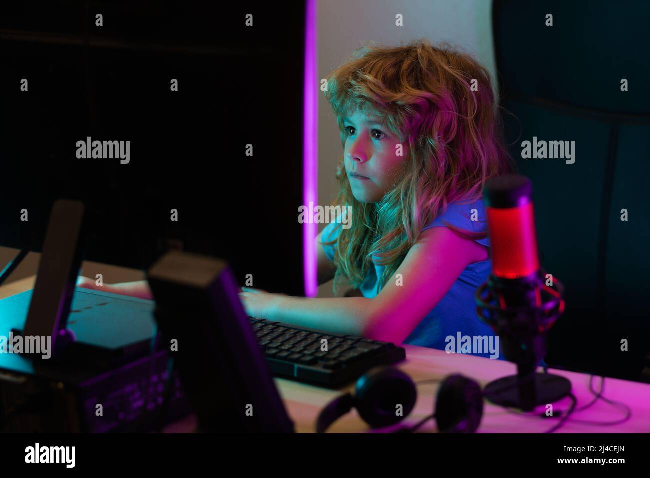 Kid using pc at night. Child with computer in a dark room Stock Photo ...
