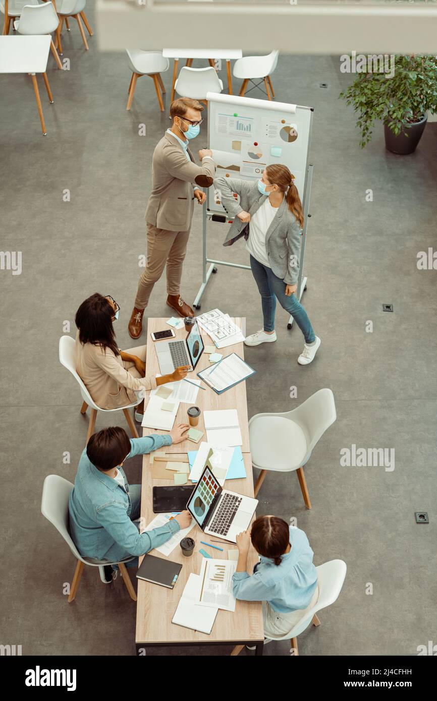 Two colleagues standing in the meeting room in the office Stock Photo ...